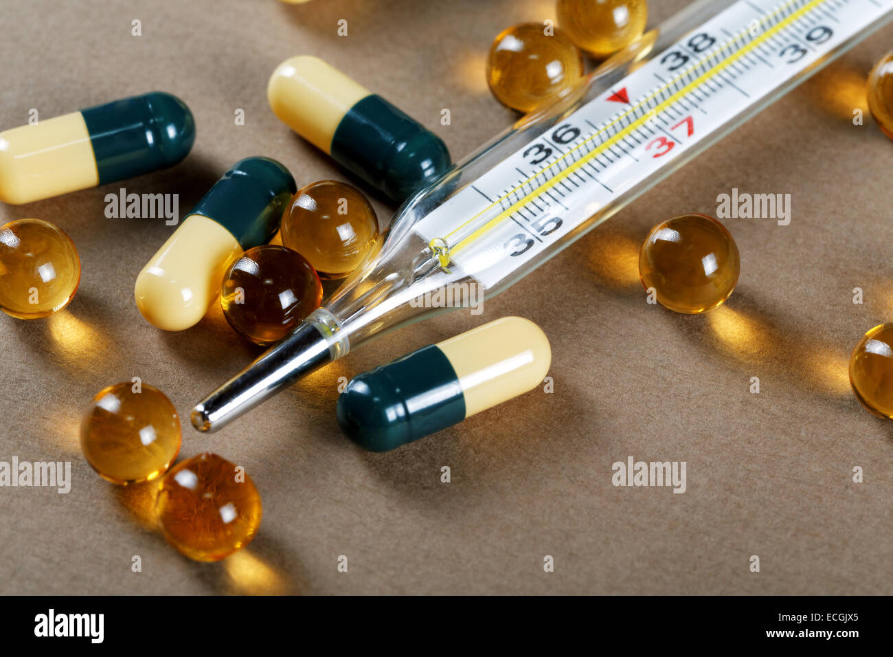 The thermometer and capsules with medicines close up Stock Photo - Alamy
