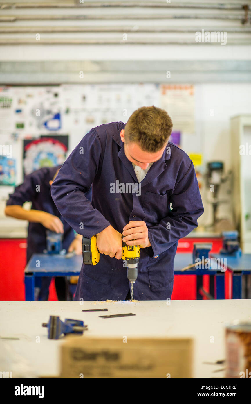 Secondary education,a boy using a power drill - vocational training for ...