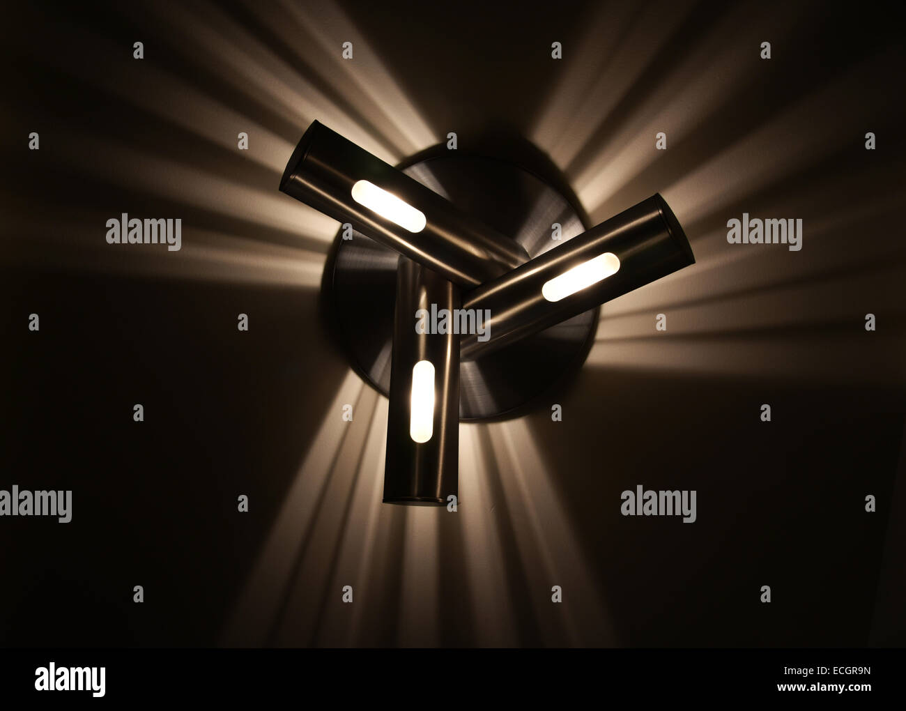 A modern light throws beams of light onto the ceiling Stock Photo - Alamy