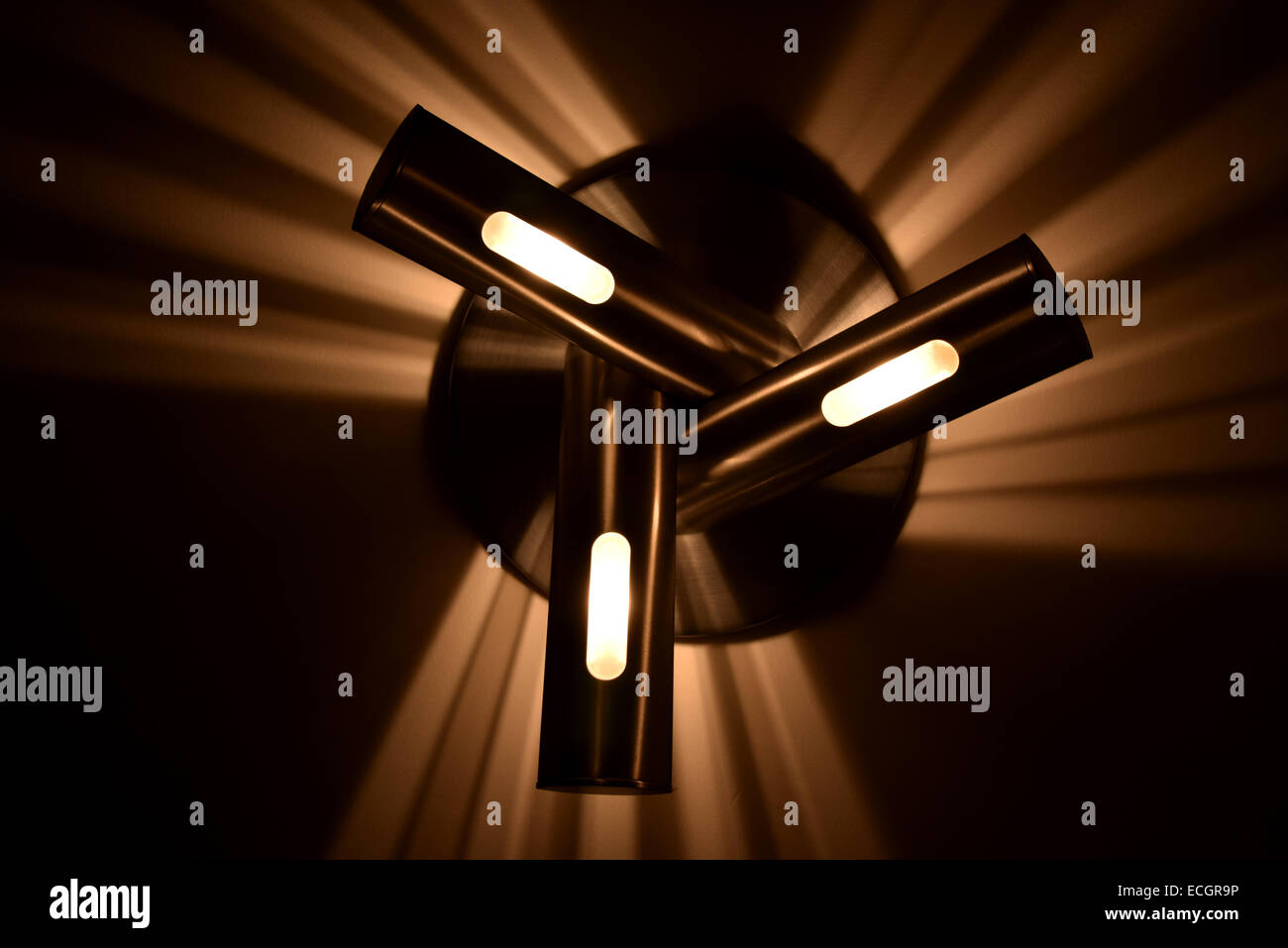 A modern light throws beams of light onto the ceiling Stock Photo - Alamy