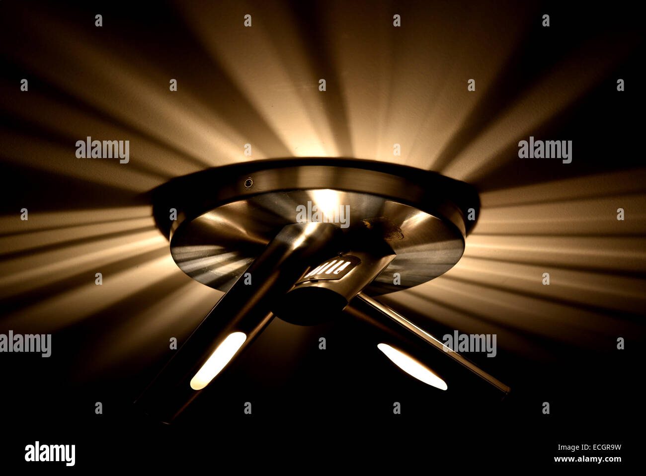 A modern light throws beams of light onto the ceiling Stock Photo - Alamy