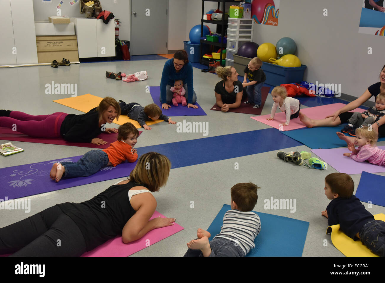 Infants doing yoga in daycare Stock Photo - Alamy