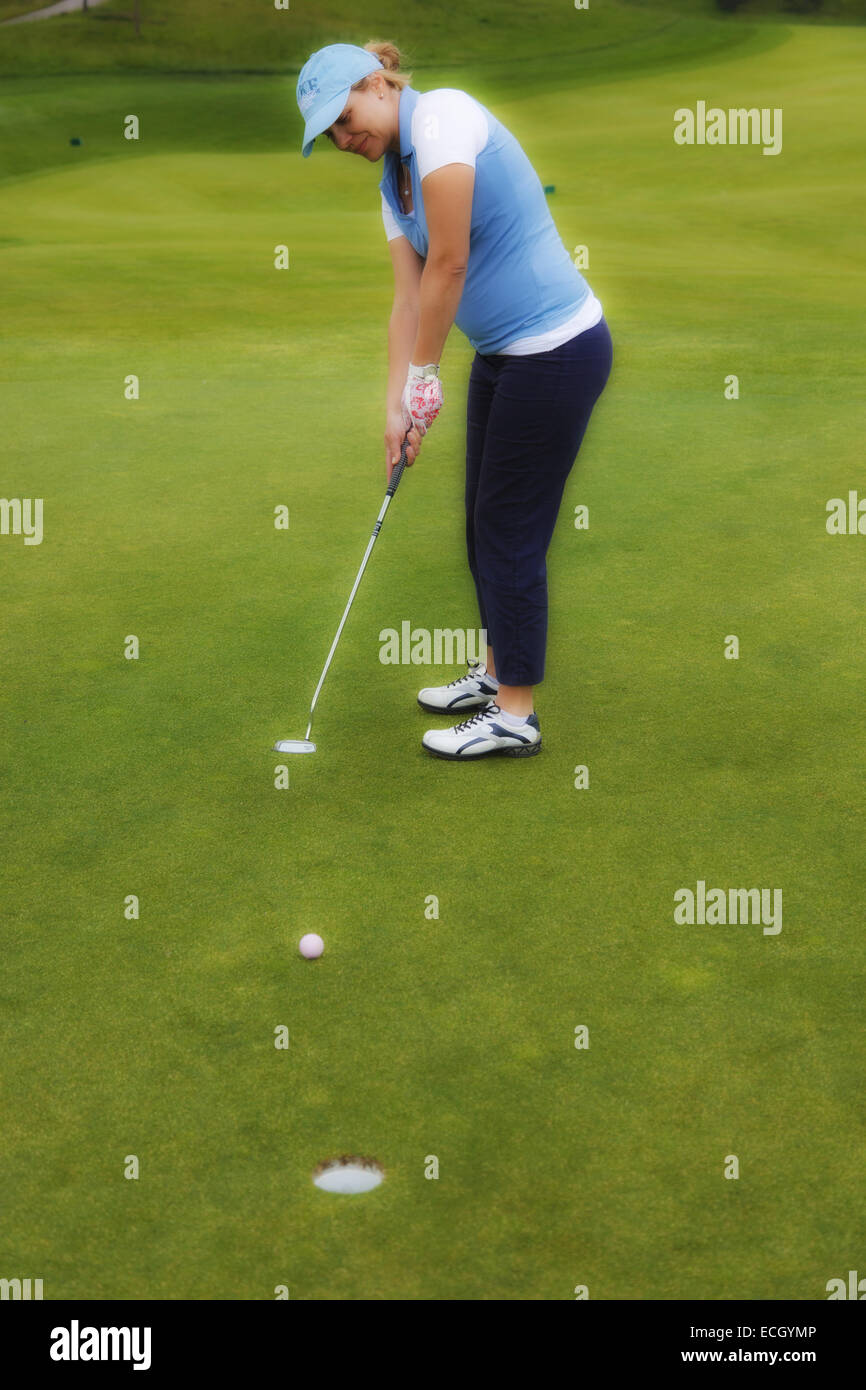 young woman playing golf Stock Photo - Alamy