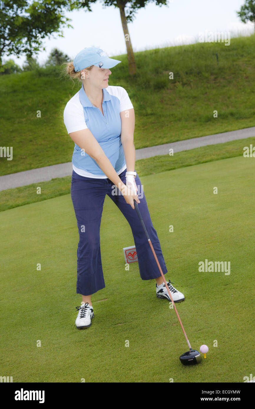 young woman playing golf Stock Photo - Alamy