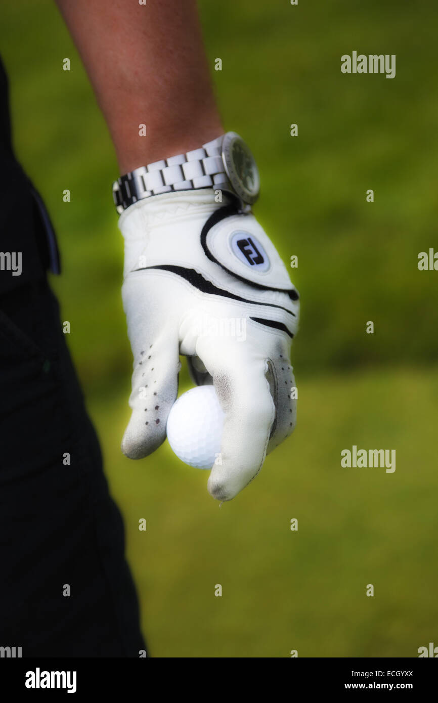 man holding golf ball Stock Photo - Alamy