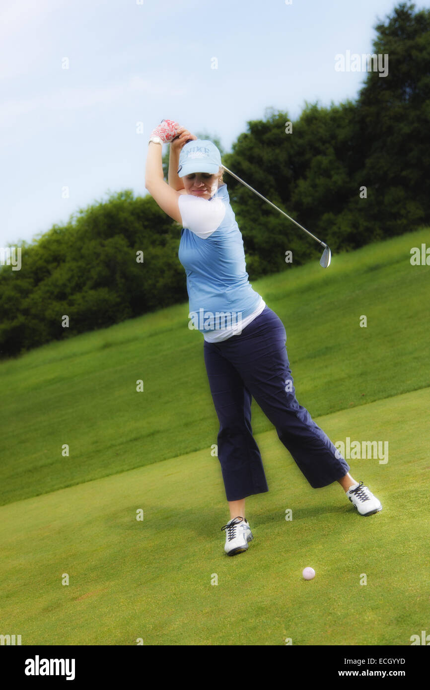young woman playing golf Stock Photo - Alamy