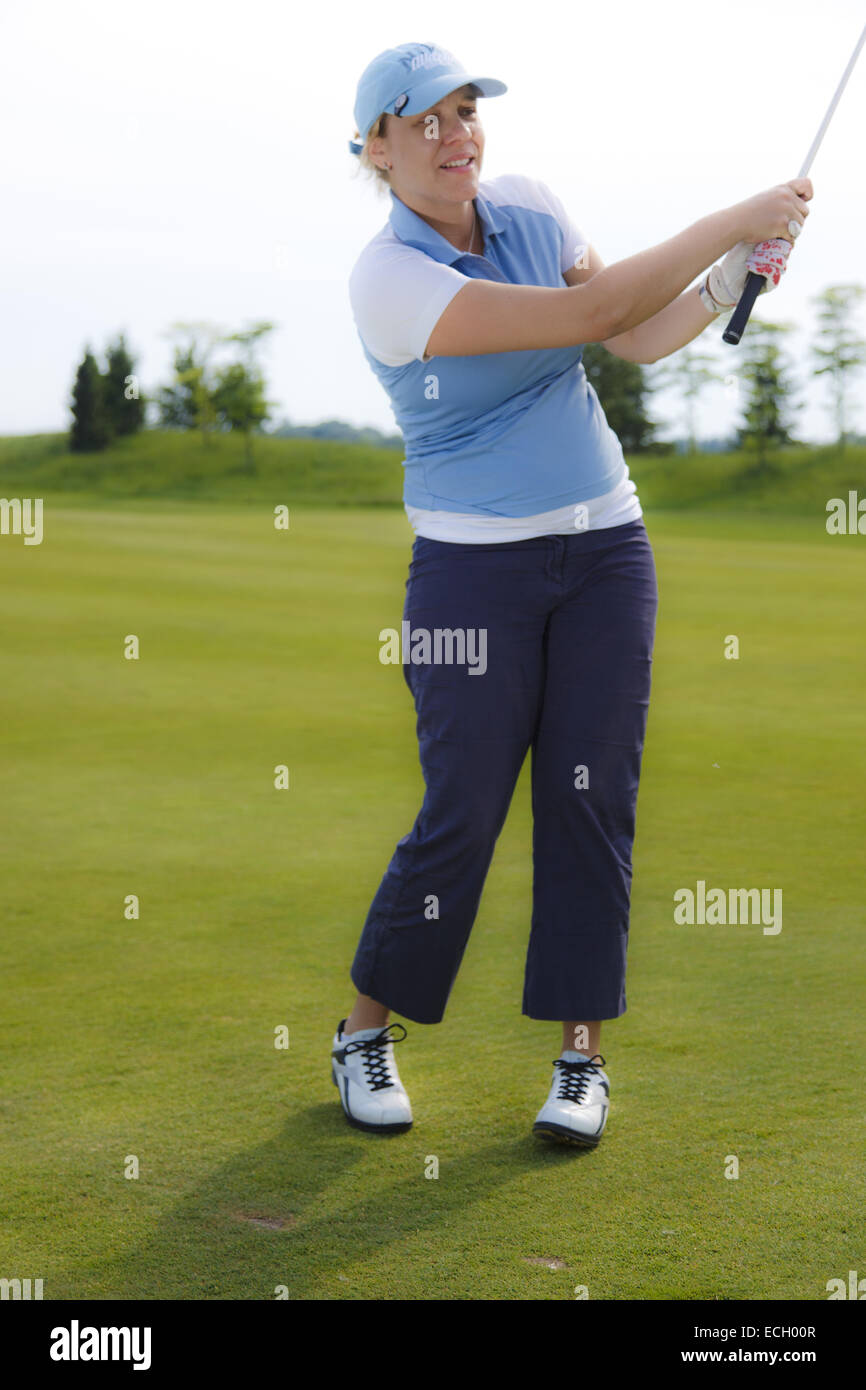 young woman playing golf Stock Photo - Alamy