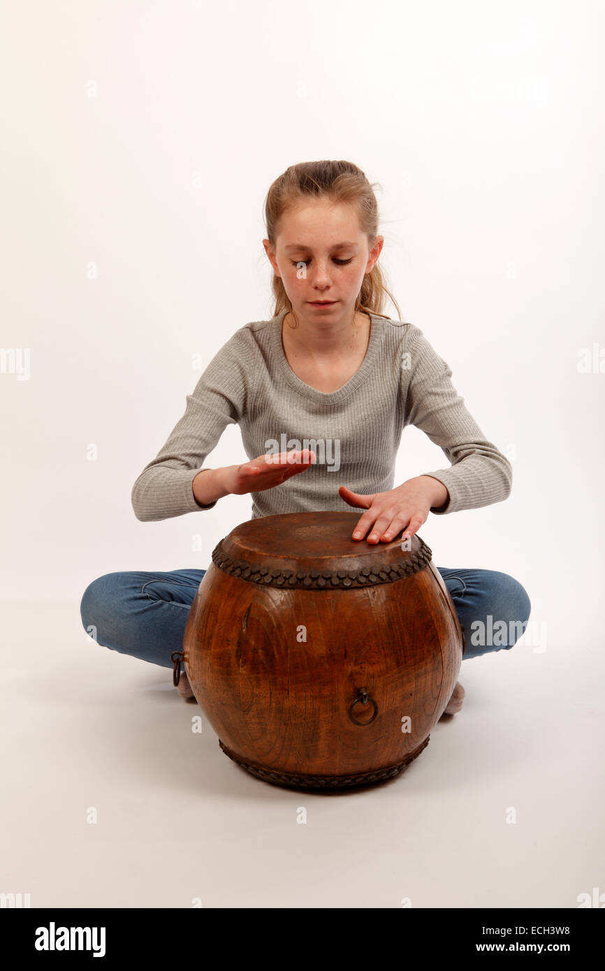young girl playing a hand drum, a chinese double headed tom tom Stock ...