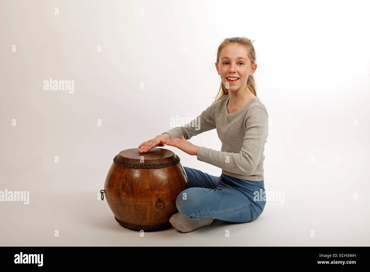 young girl playing a hand drum, a chinese double headed tom tom Stock ...