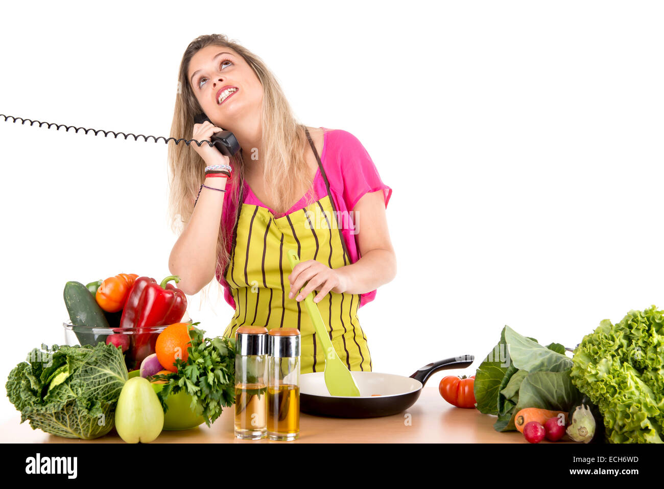 Beautiful woman cooking and speaking at telephone Stock Photo - Alamy