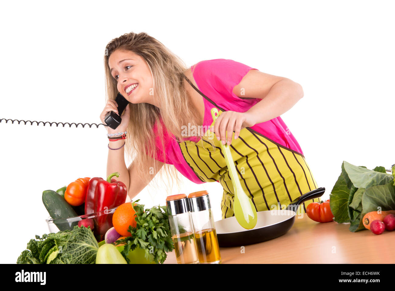 Beautiful woman cooking and speaking at telephone Stock Photo - Alamy