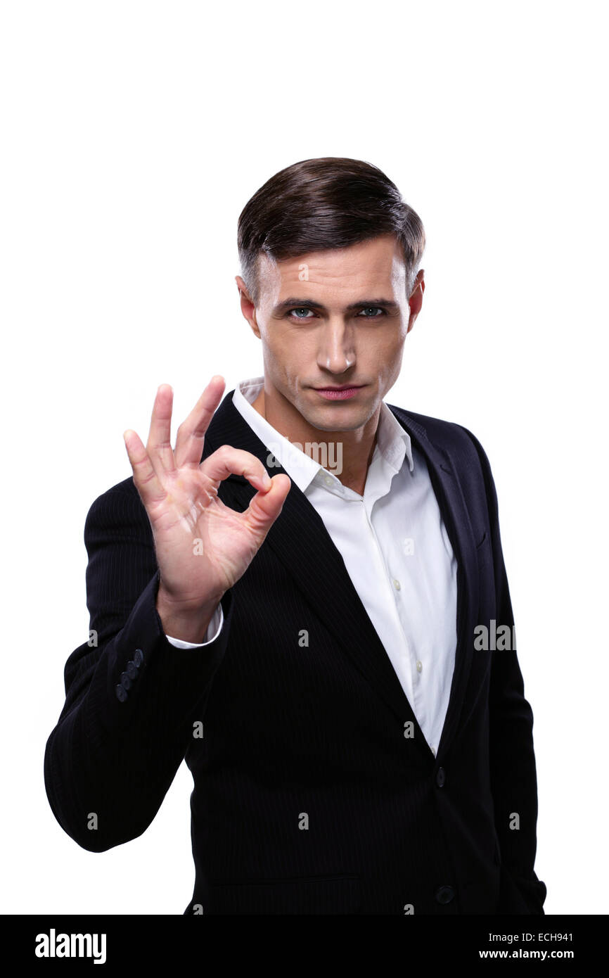 Young confident businessman gesturing OK sign over white background ...