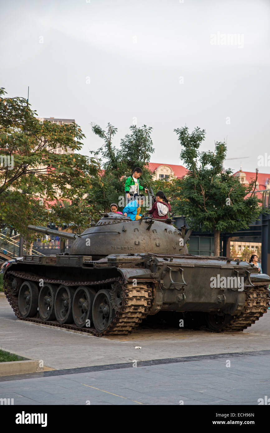 Children playing on army tank statue, Tianjin, China Stock Photo - Alamy