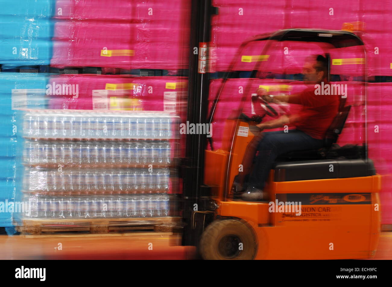 Warehouse workers moving boxes from shelf with forklift Stock Photo - Alamy