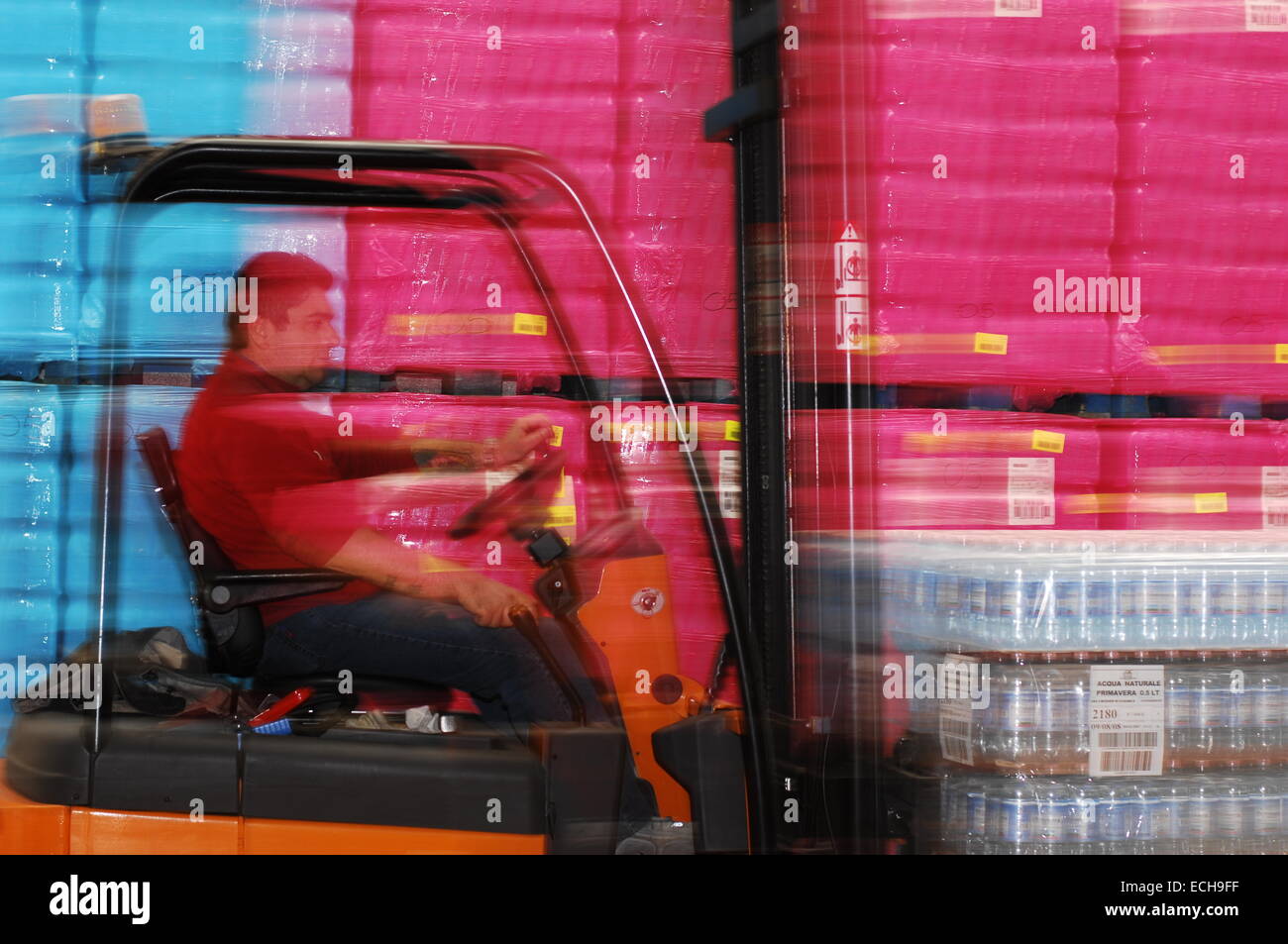 Warehouse workers moving boxes from shelf with forklift Stock Photo - Alamy