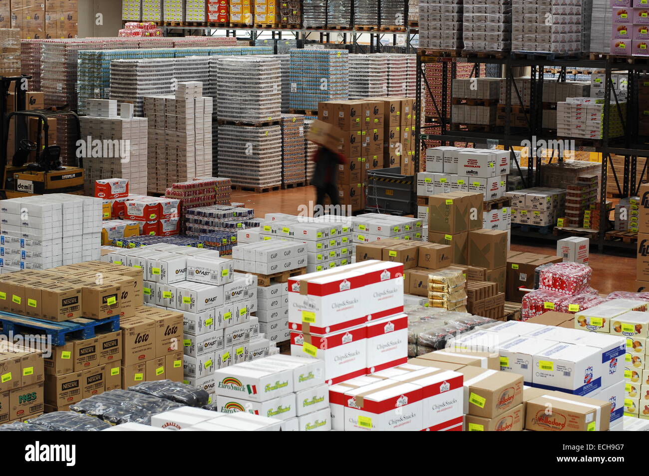 Warehouse workers moving boxes from shelf with forklift Stock Photo - Alamy