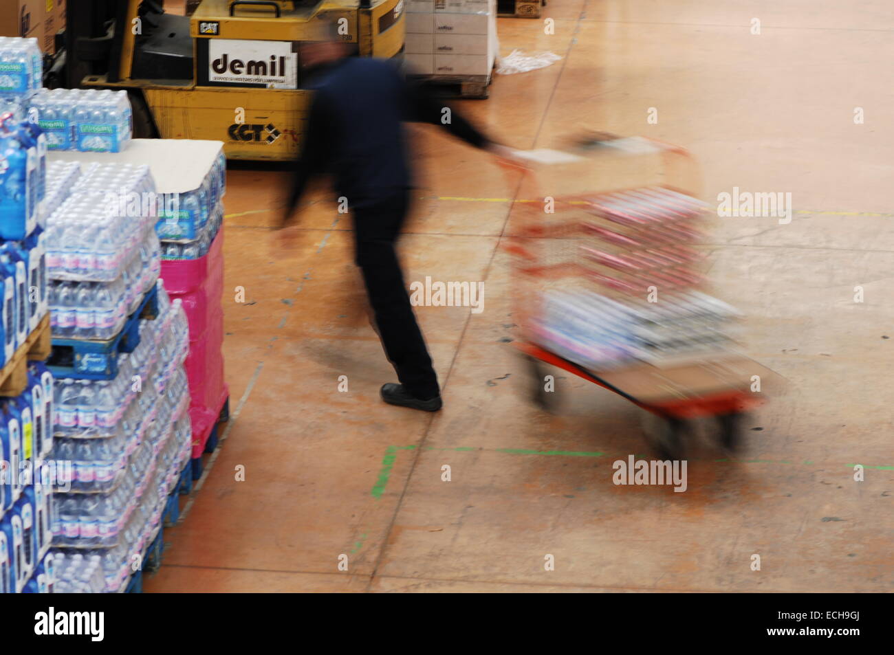 Warehouse workers moving boxes from shelf with forklift Stock Photo - Alamy