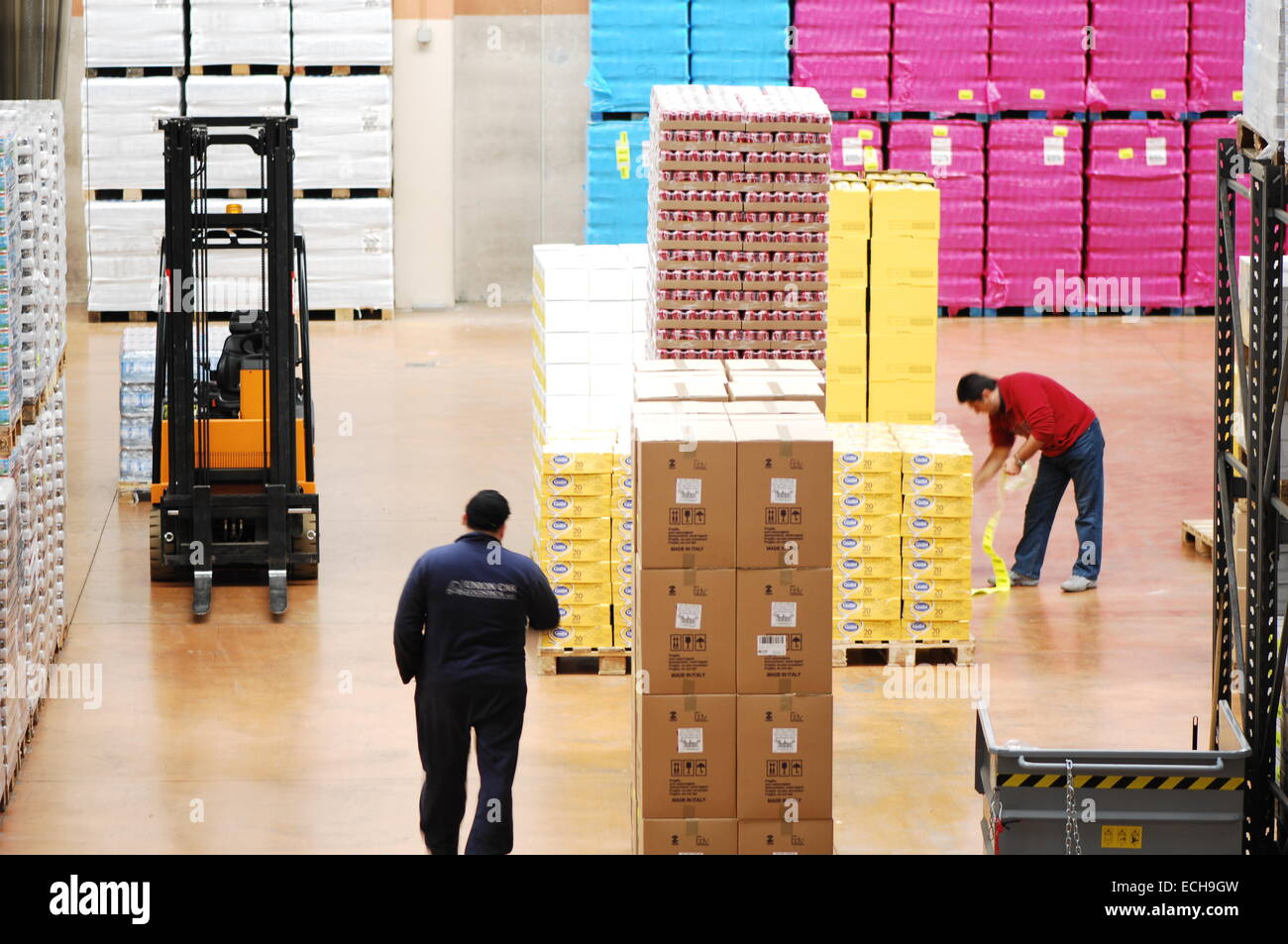 Warehouse workers moving boxes from shelf with forklift Stock Photo - Alamy