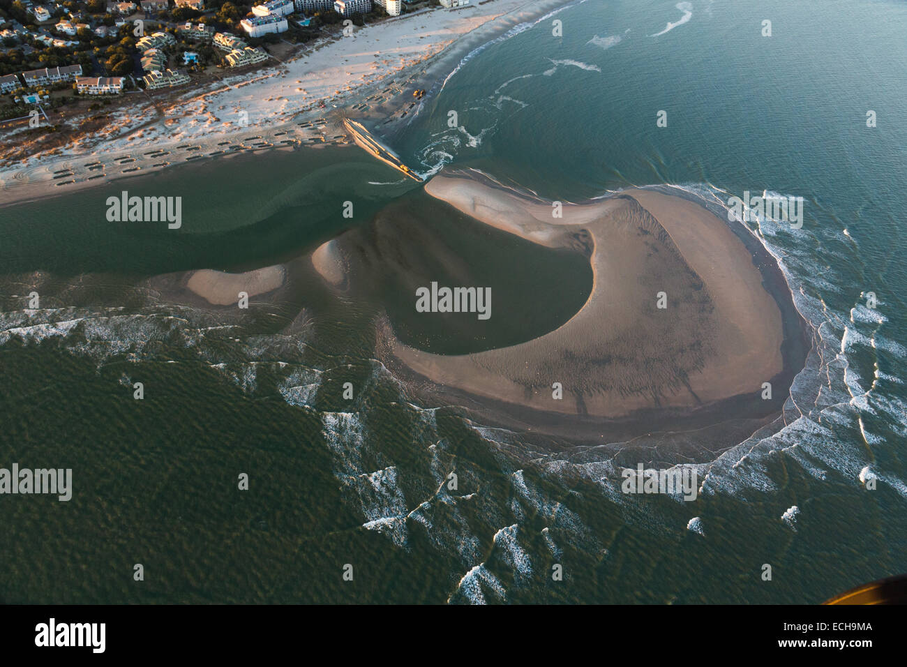 Aerial view of a manmade island emerging offshore during a beach ...