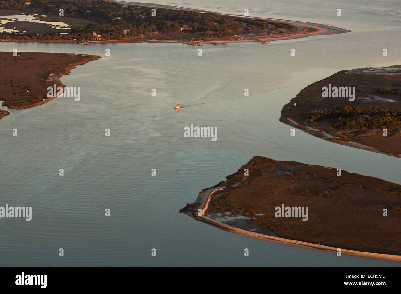 Aerial view of a boat entering the intracoastal waterway from an inlet ...