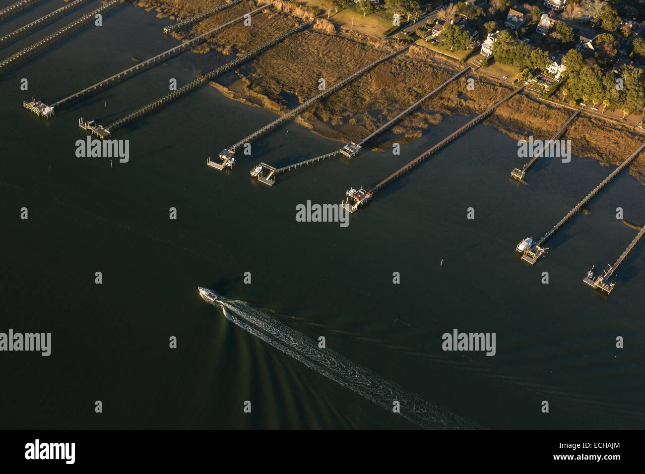 Aerial view of a boat passing through a channel past boat docks in Mt ...