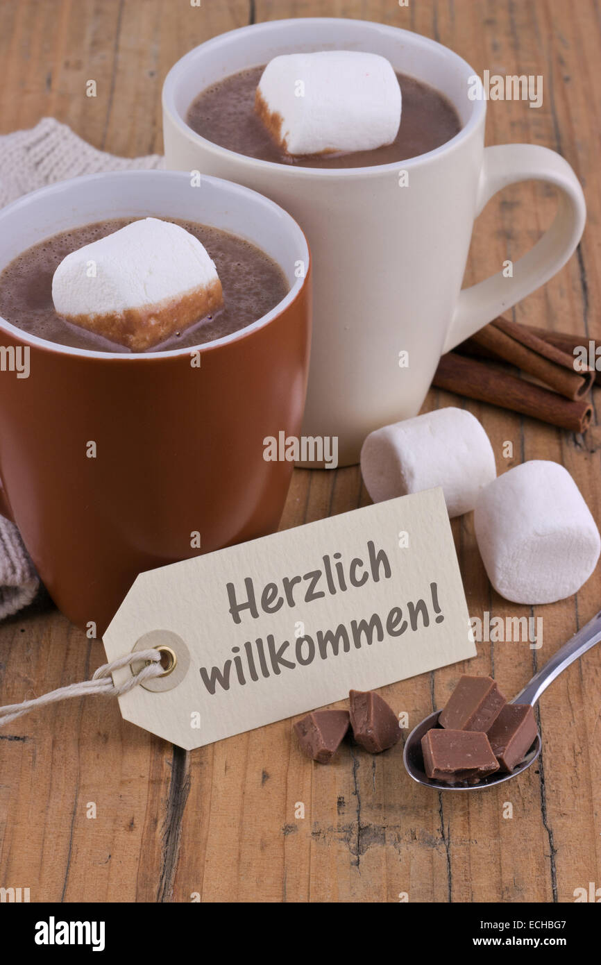 two cups of hot chocolate and card with lettering welcome Stock Photo ...