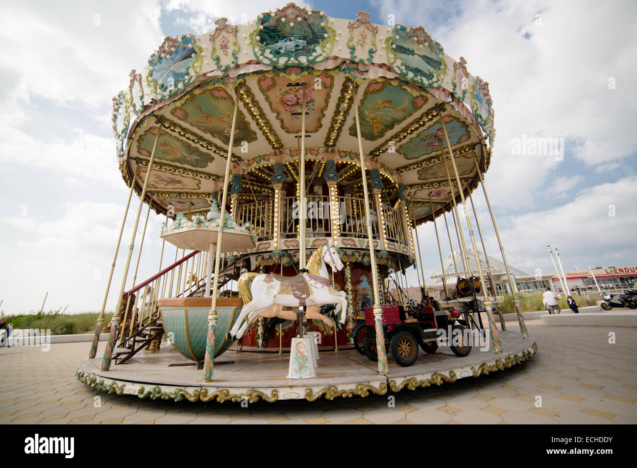 A traditional carousel or merry-go-round at a French seaside holiday ...