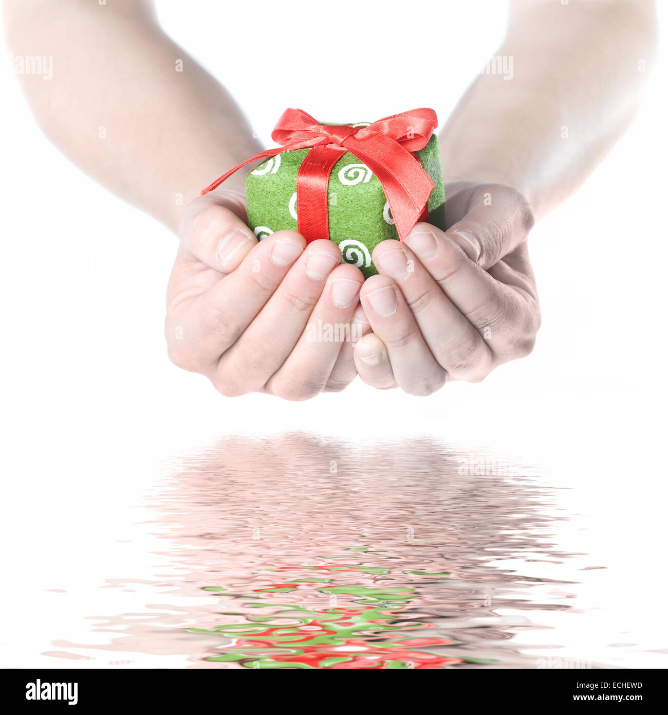 Hands holding gift with reflection isolated on white Stock Photo - Alamy