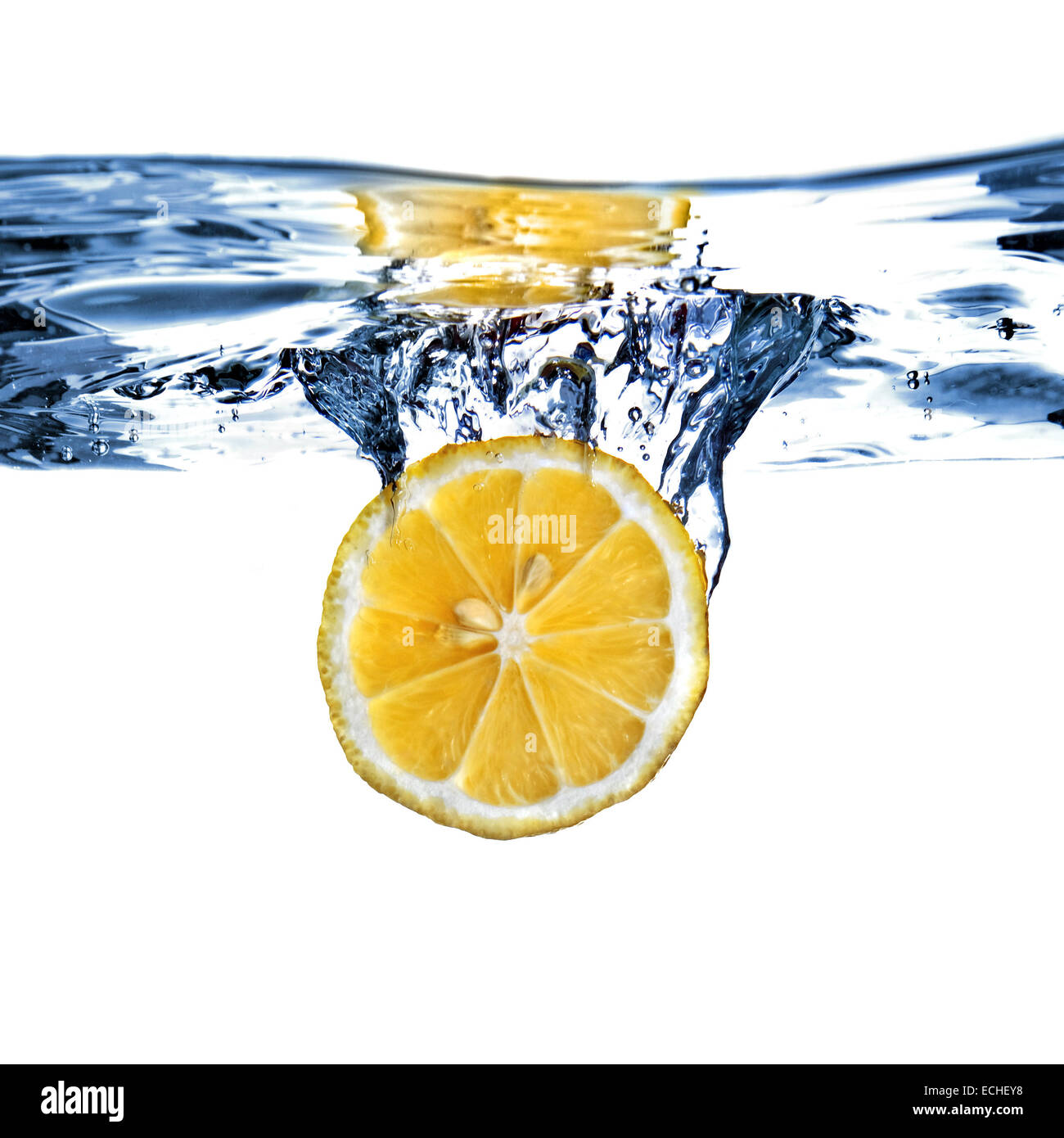Fresh lemon dropped into water with bubbles isolated on white Stock ...