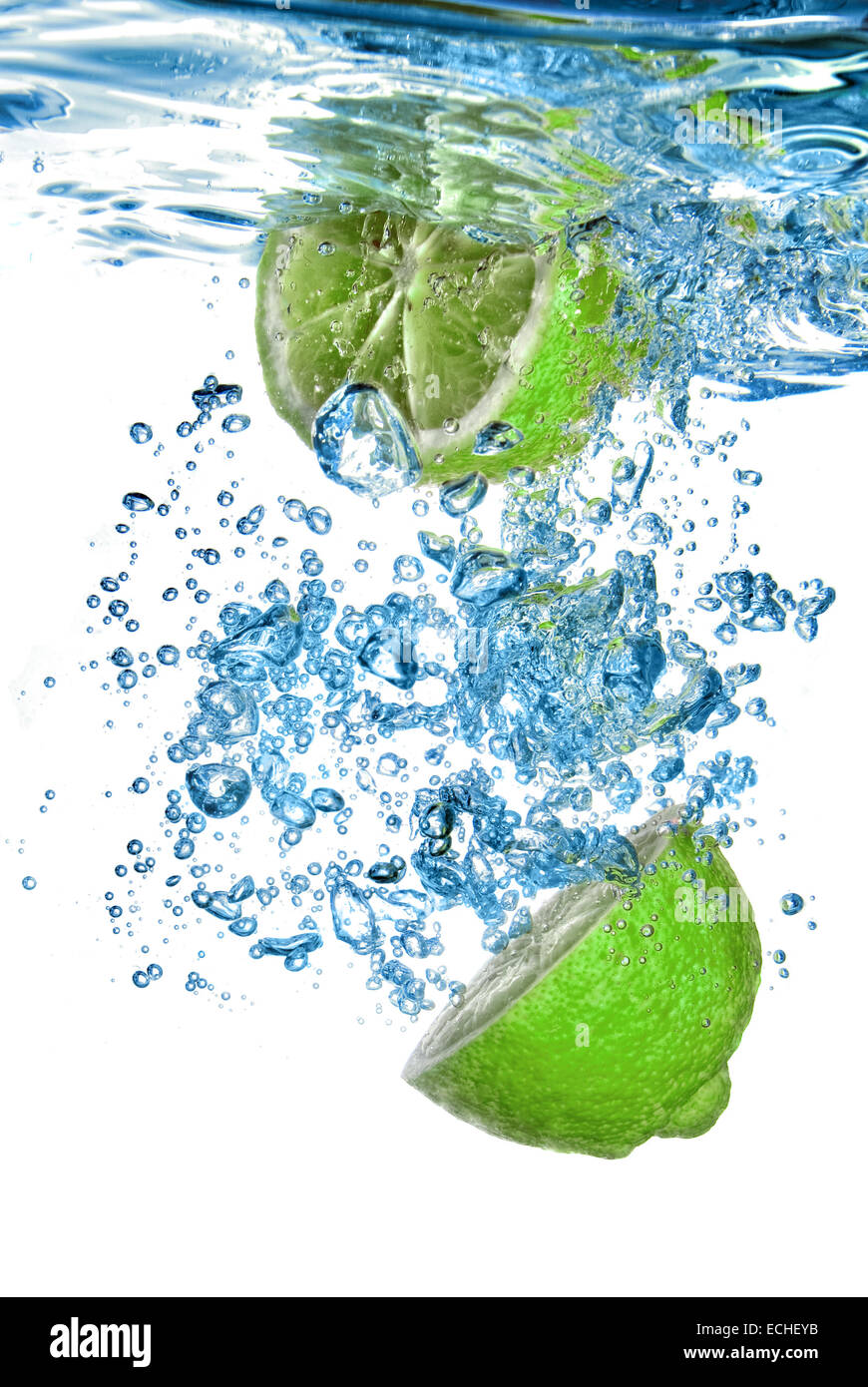 Fresh lime dropped into water with bubbles isolated on white Stock ...