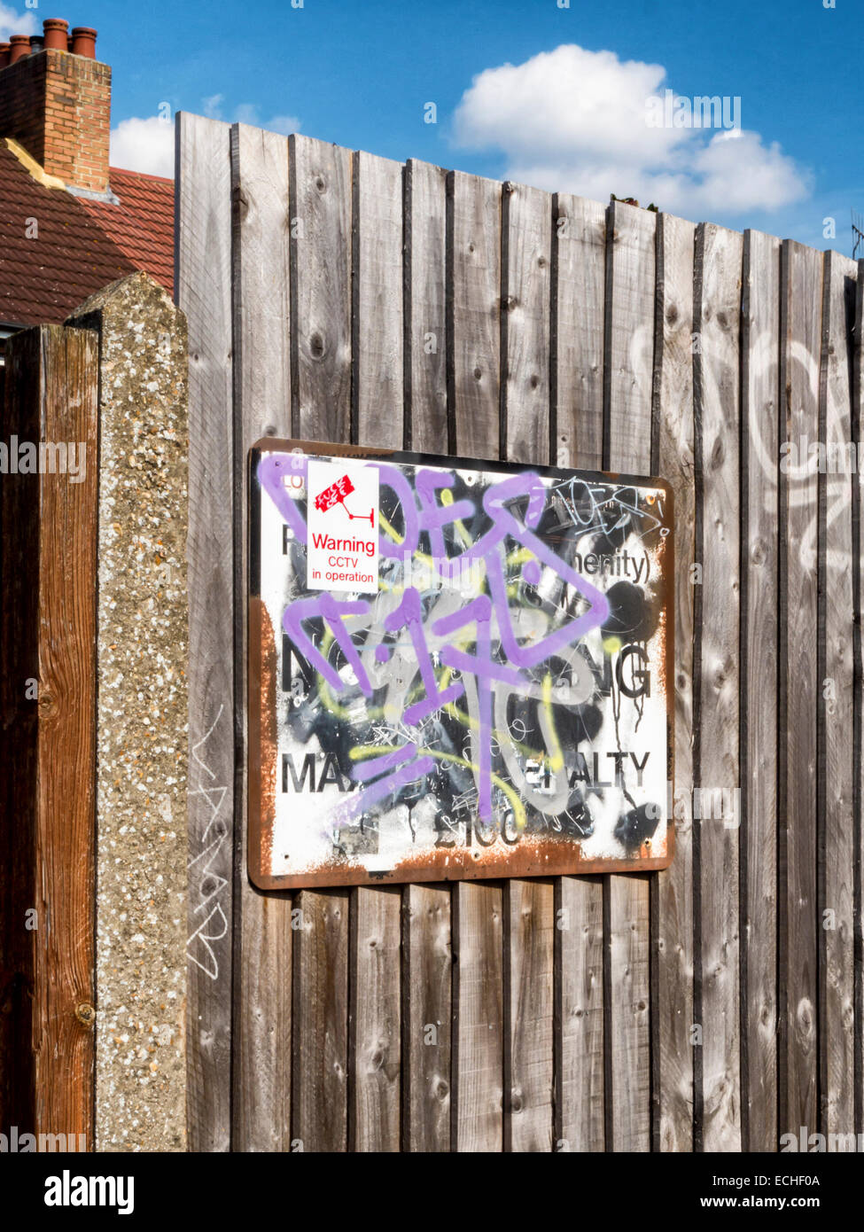 Wooden fence, graffiti, sign and CCTV camera sign Stock Photo - Alamy