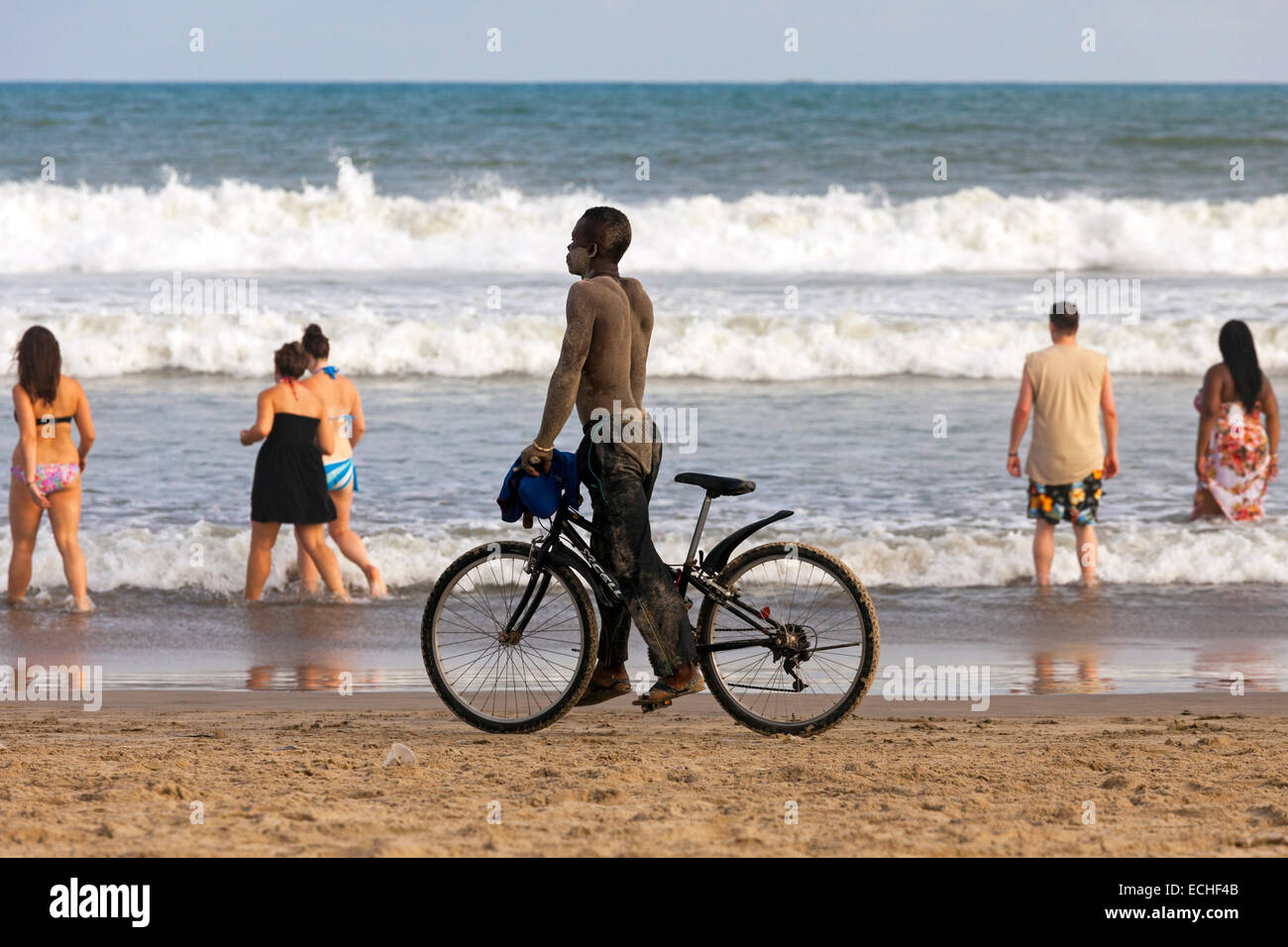 Cyclist and swimmers on Labadi beach, Accra, Ghana, Africa Stock Photo ...
