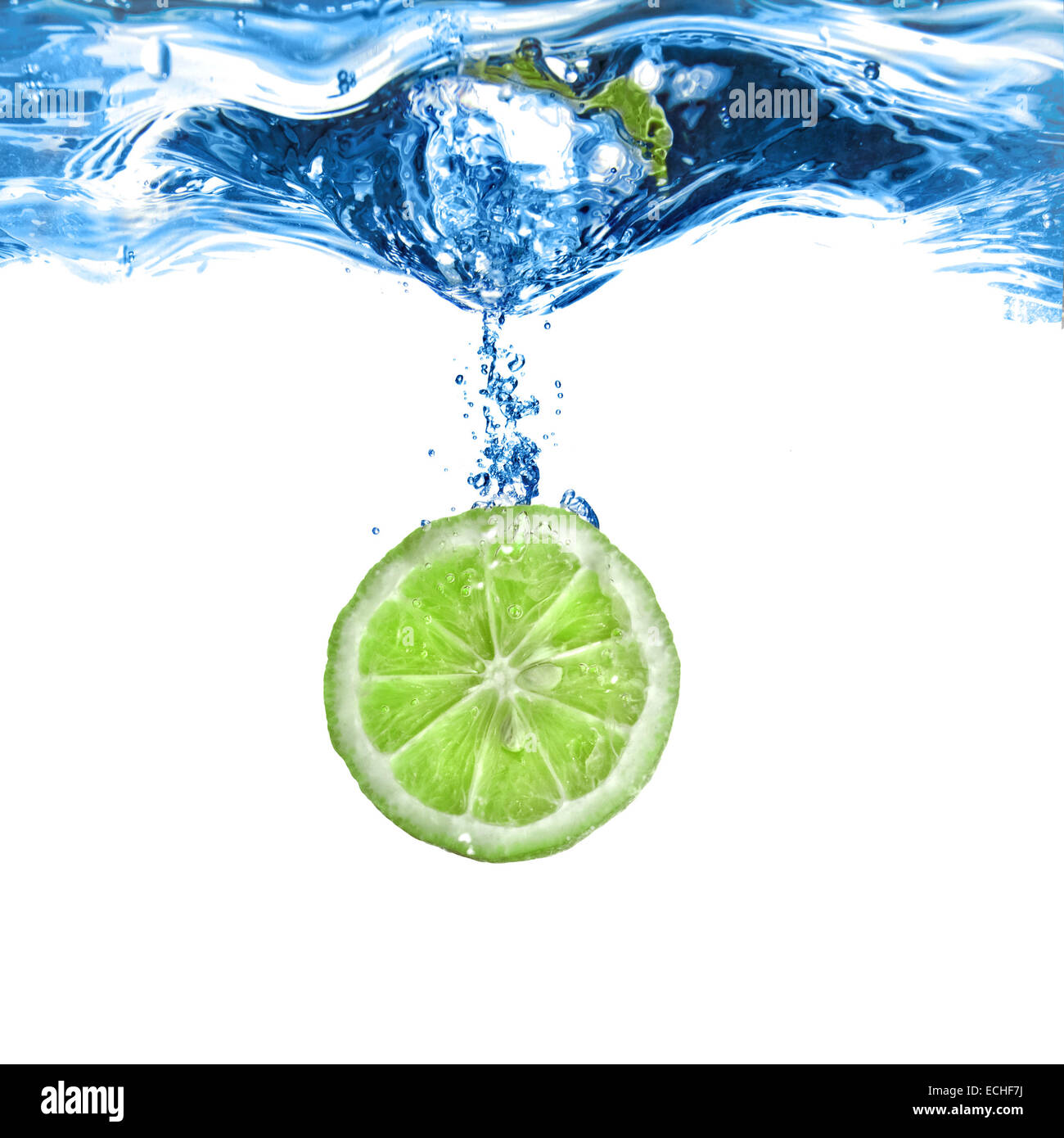 Fresh lime dropped into water with bubbles isolated on white Stock ...