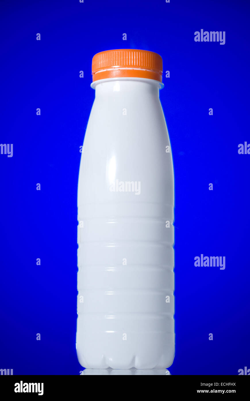 White milk bottle isolated on blue Stock Photo - Alamy
