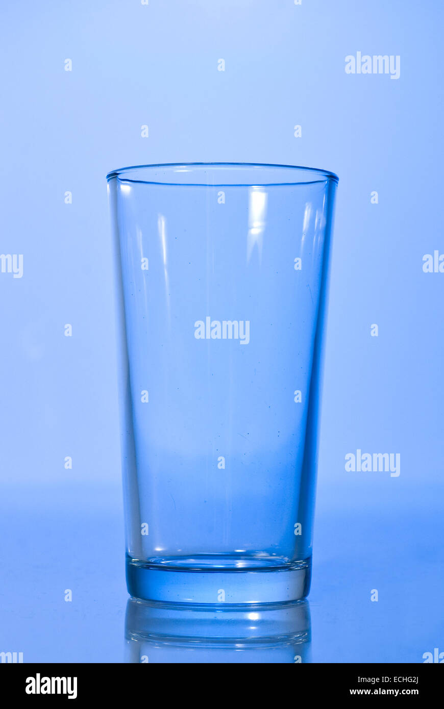 empty glass on blue Stock Photo - Alamy