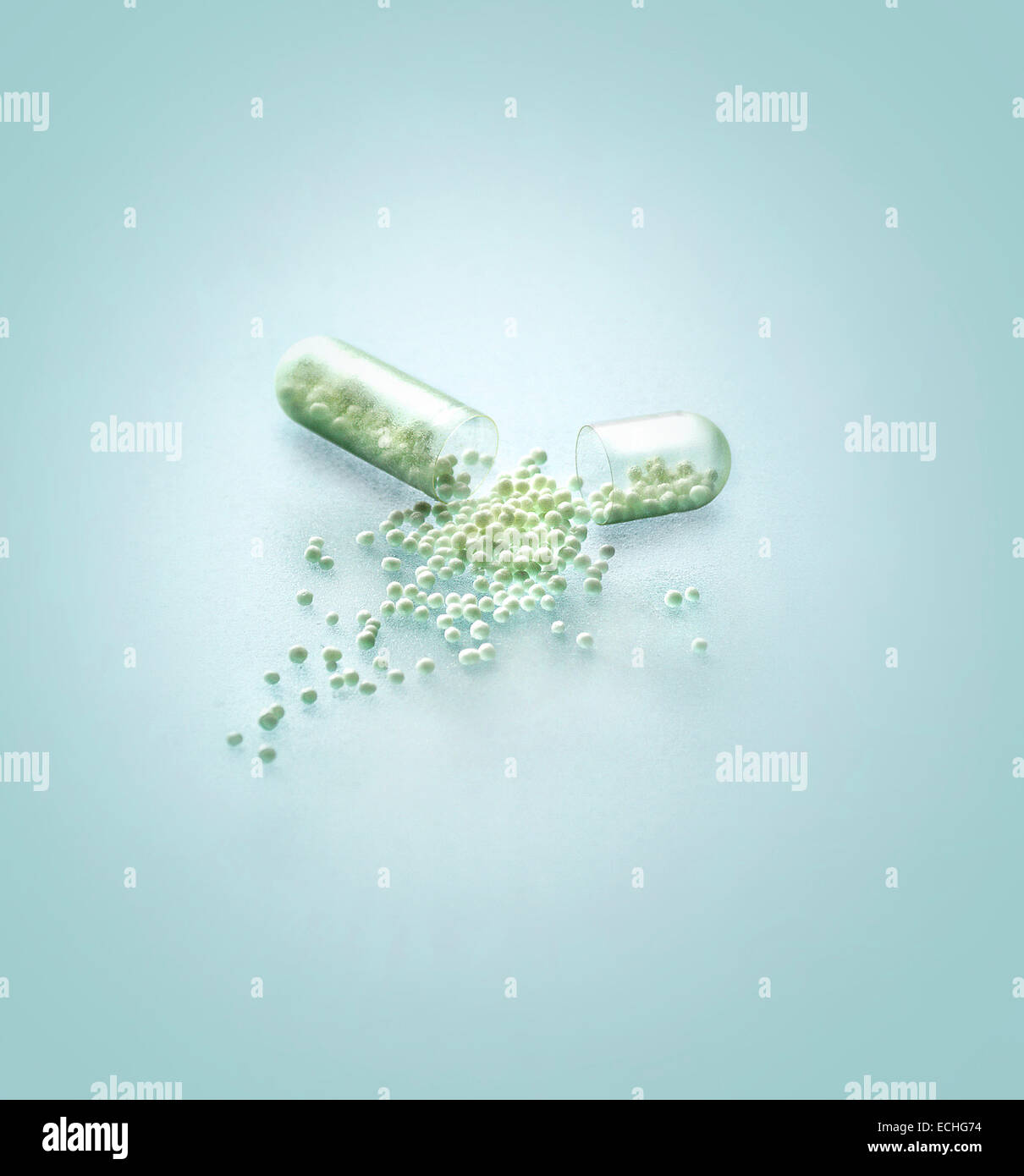 A pill capsule opened with contents spilling out Stock Photo - Alamy
