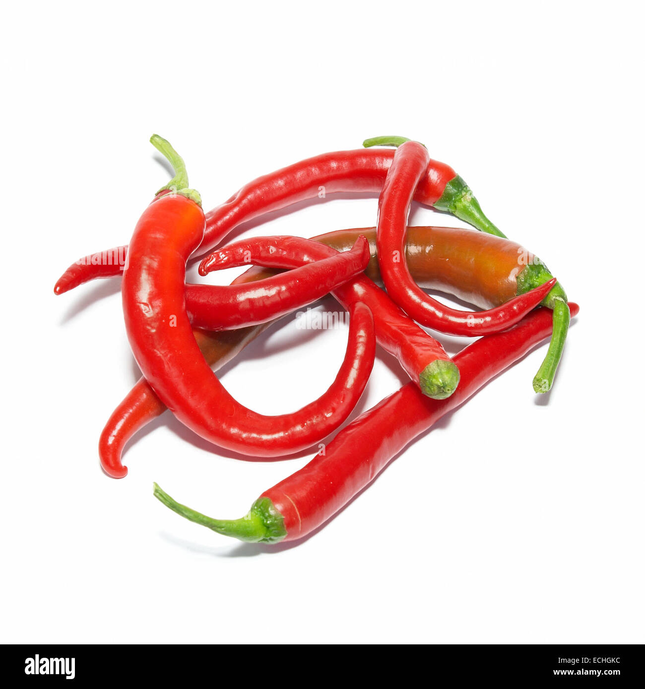 Stack of red hot chili peppers isolated on white Stock Photo - Alamy