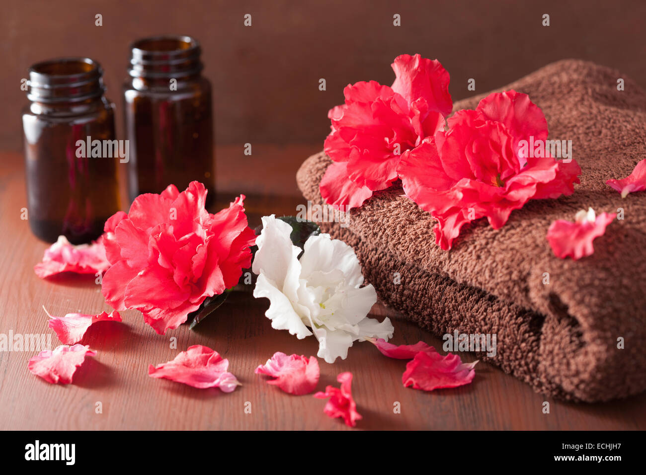 spa bathroom with azalea flowers essential oil on dark rustic ...