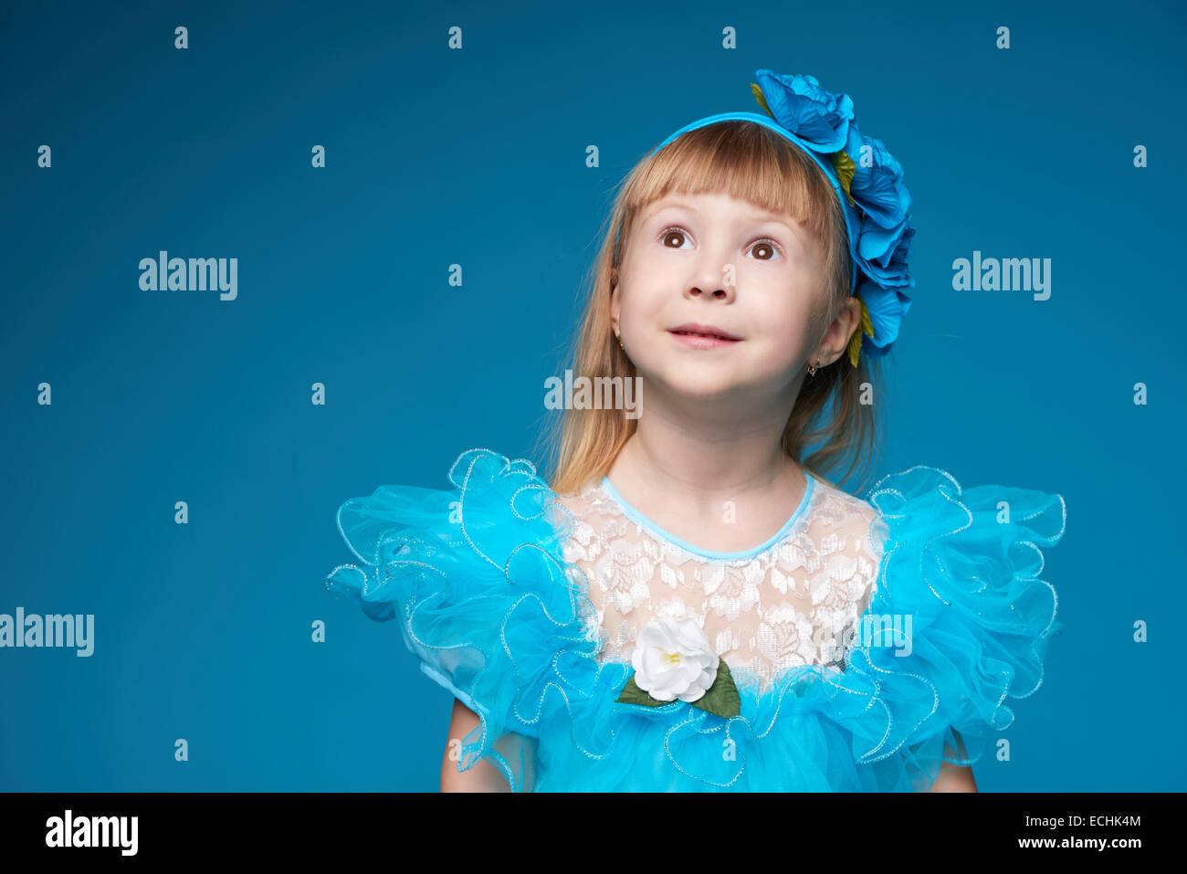 portrait of cute little girl on blue background Stock Photo - Alamy