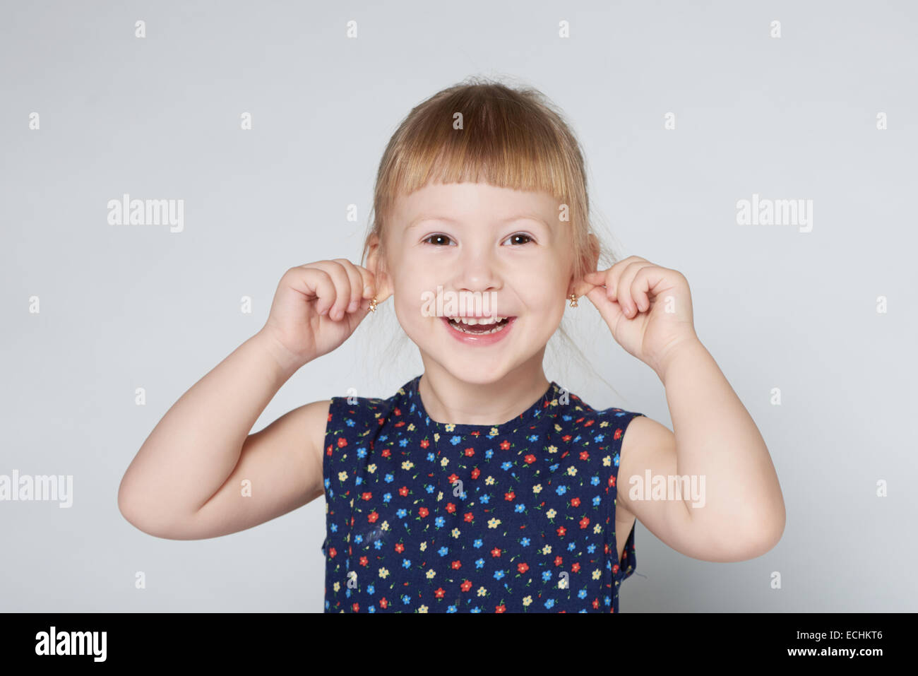 portrait of little cute girl grimacing on white Stock Photo - Alamy