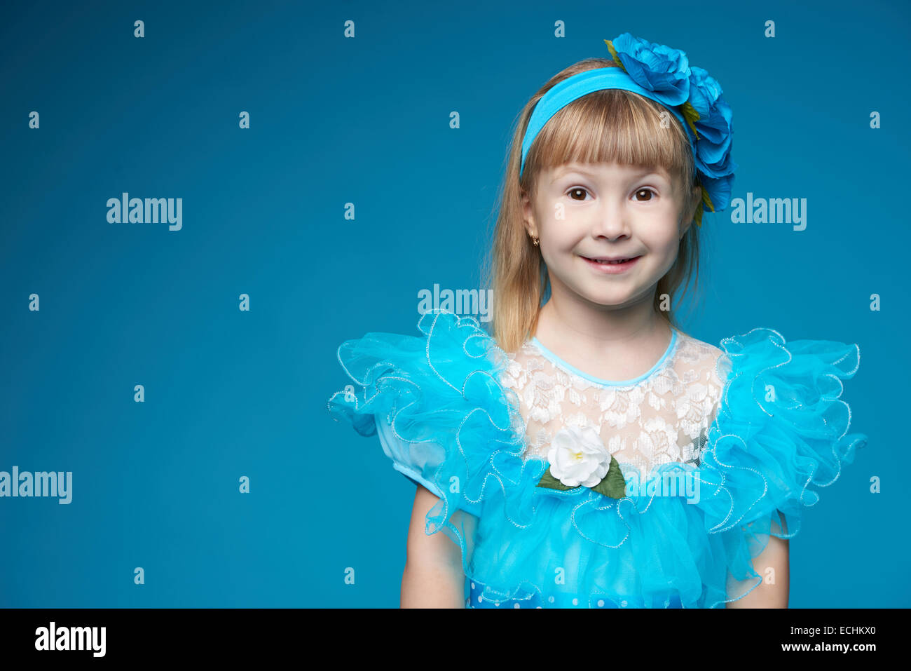 portrait of cute little girl on blue background Stock Photo - Alamy