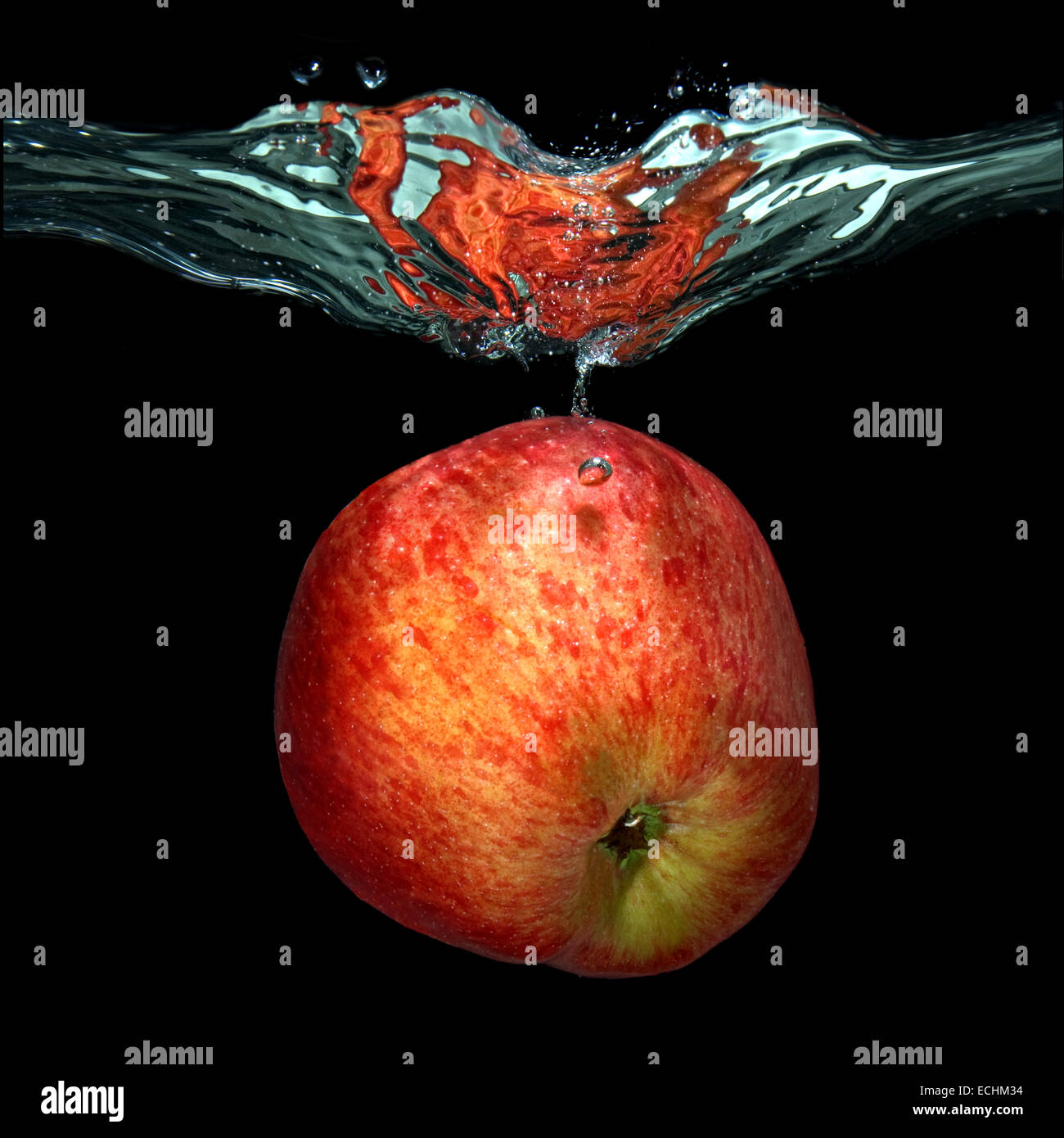 green apple dropped into water with splash isolated on black Stock ...