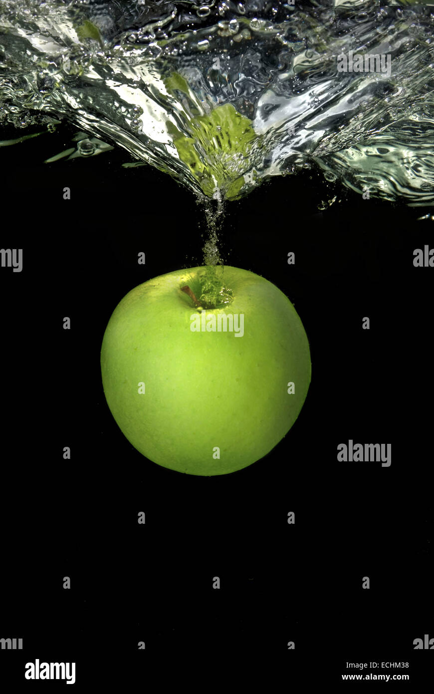 green apple dropped into water with splash isolated on black Stock ...