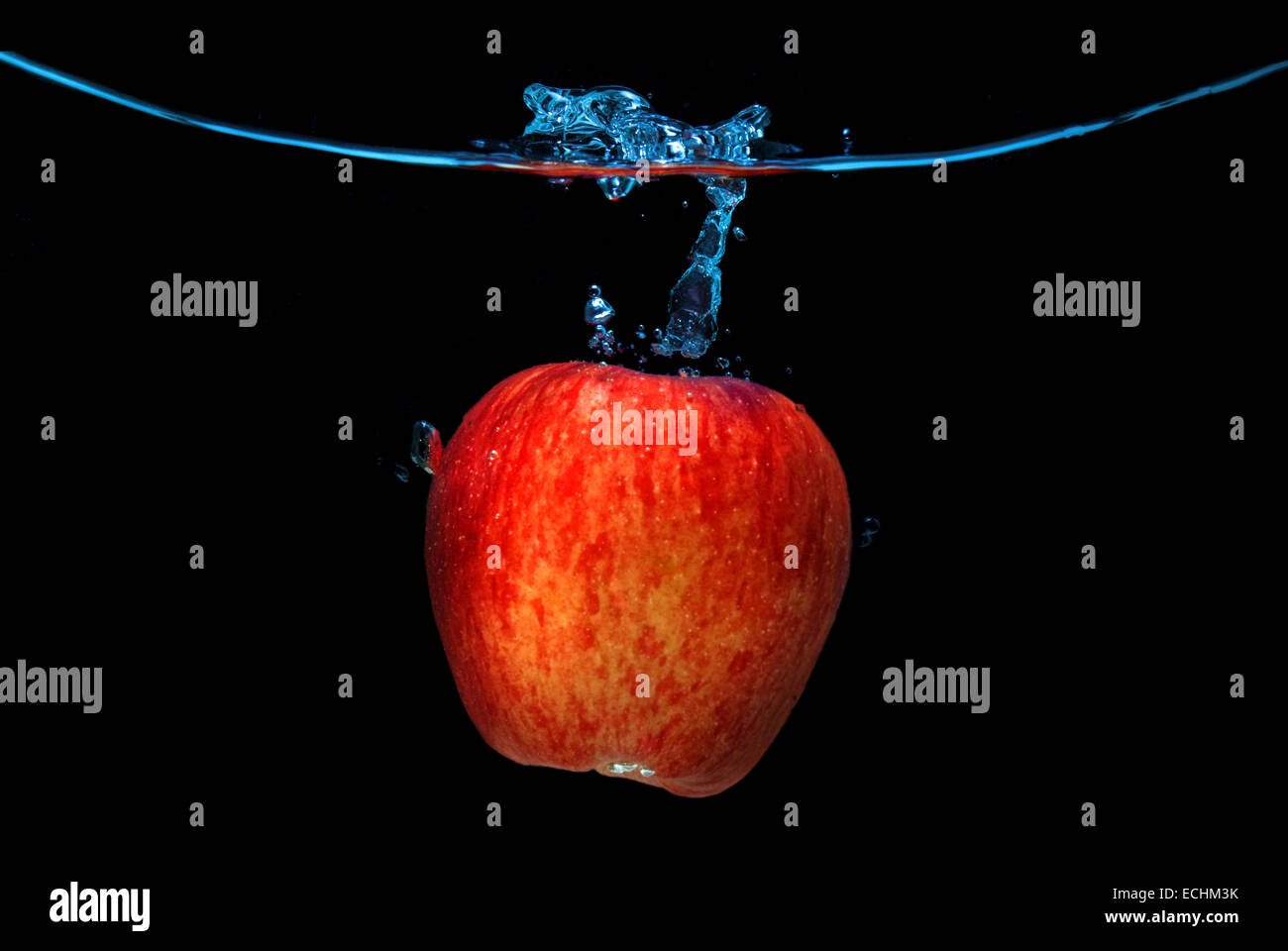 red apple dropped into water with splash isolated on black Stock Photo ...