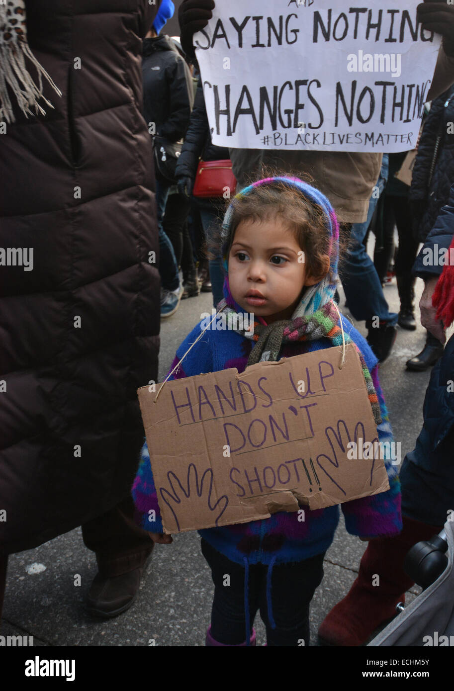 New York City, USA. 13th Dec, 2014. A little girl holds a sign during ...