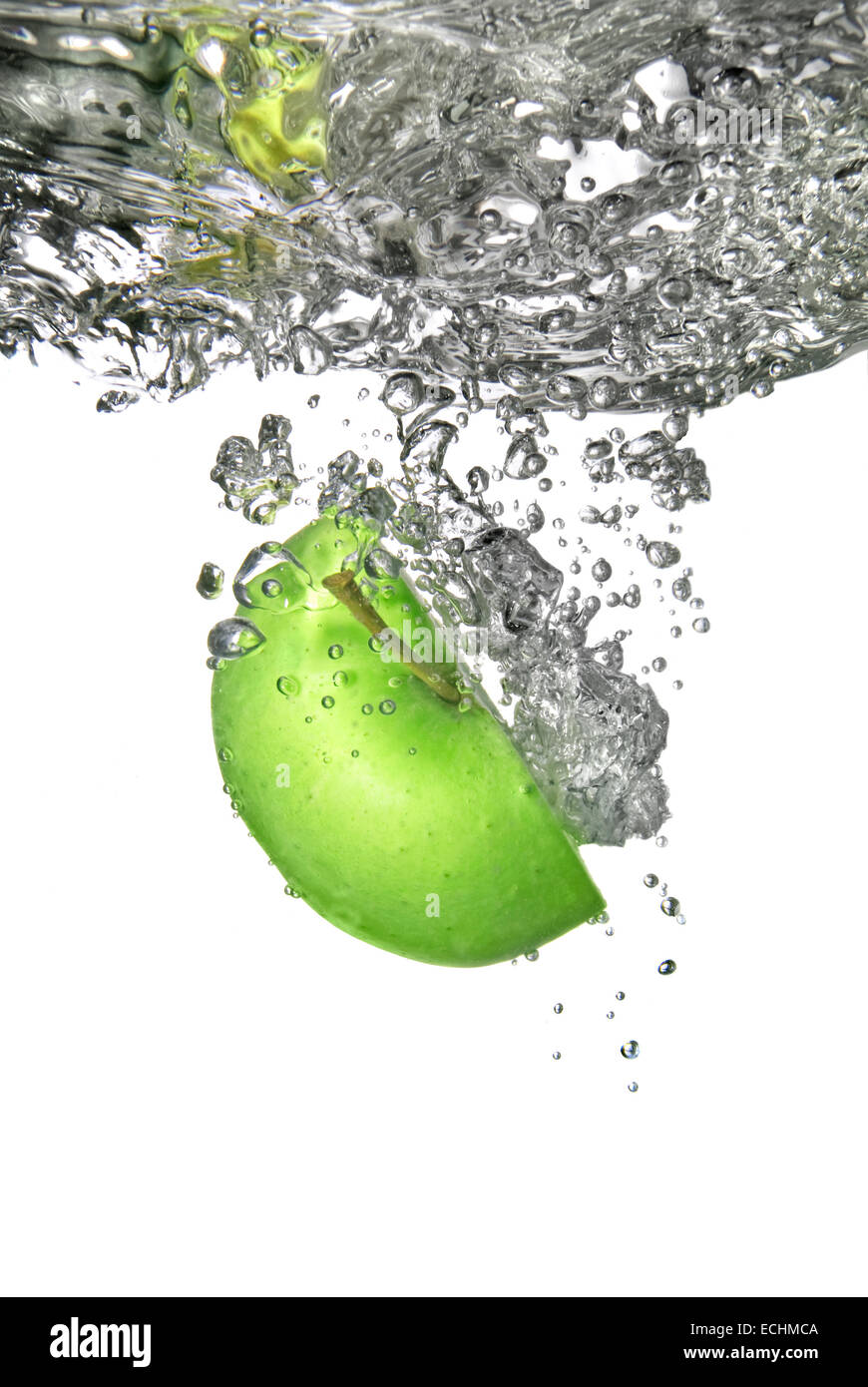 green apple dropped into water isolated on white Stock Photo - Alamy