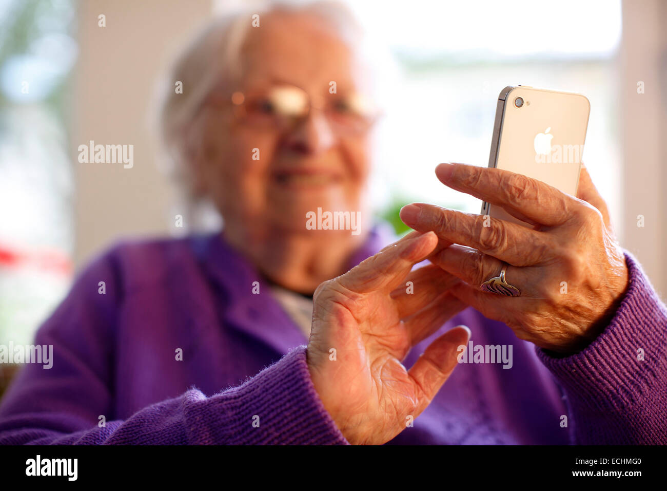 old woman (87)holding a cell phone, a home for the elderly Stock Photo ...