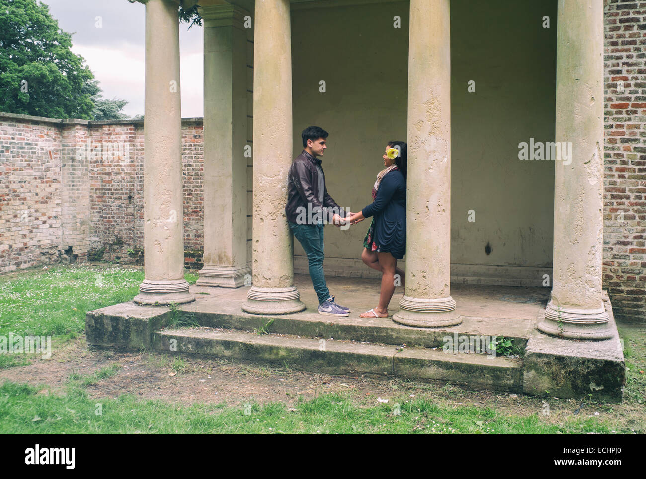 Couple by Pillars Stock Photo - Alamy