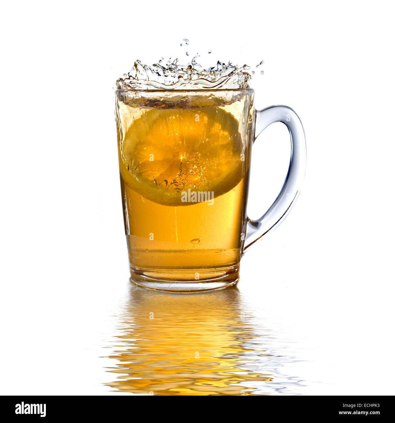 lemon dropped into tea cup with splash and reflection isolated on white ...
