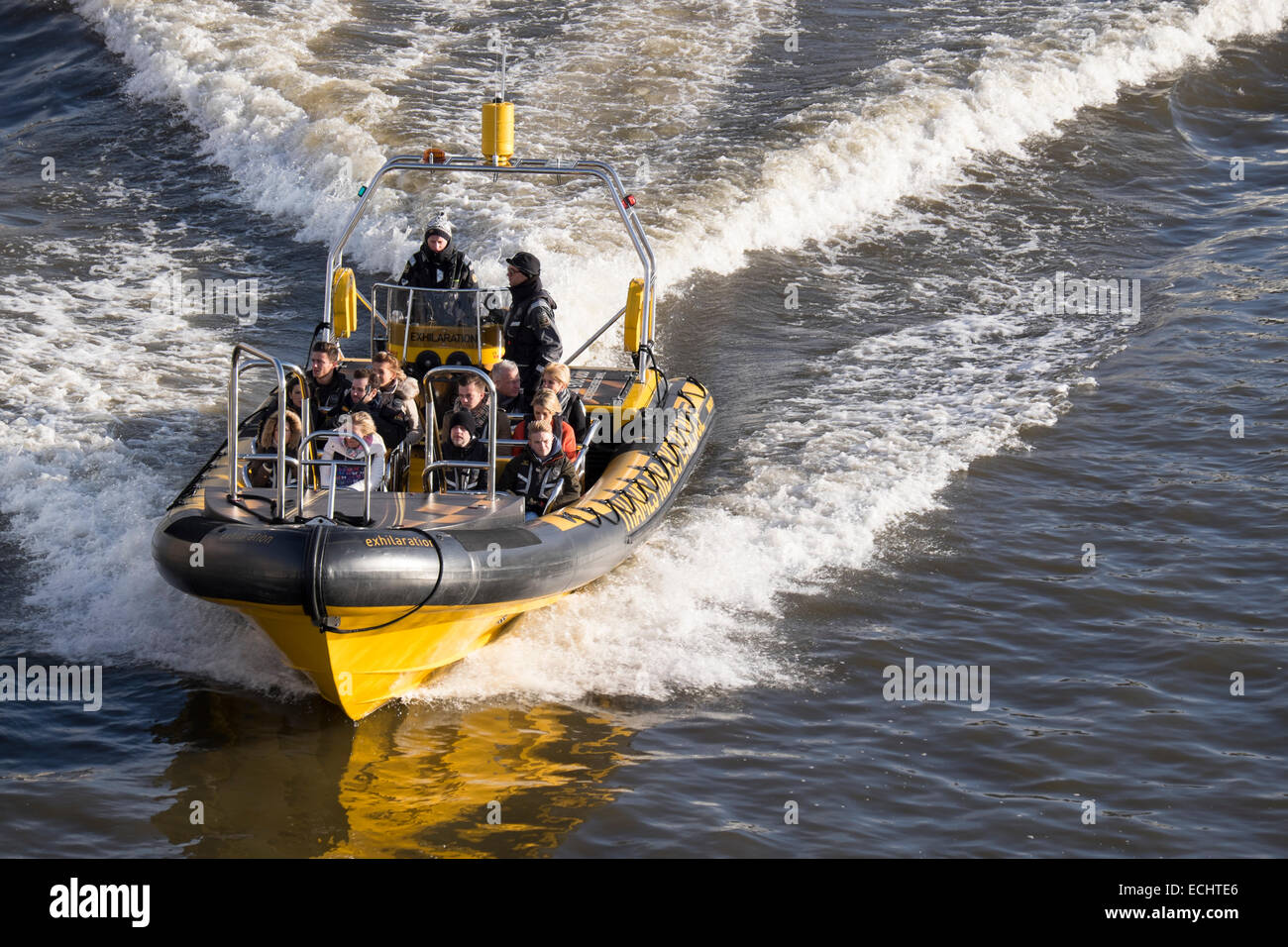 Tourists taking an excursion in a speed boat along the River Thames in ...